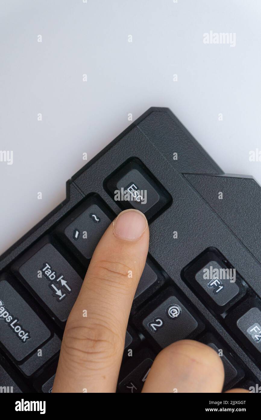A woman's finger holding a computer keyboard Stock Photo - Alamy
