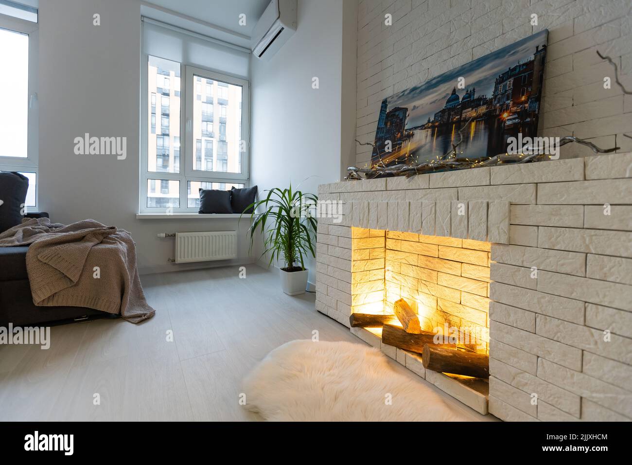 Bright living room interior with fireplace Stock Photo - Alamy