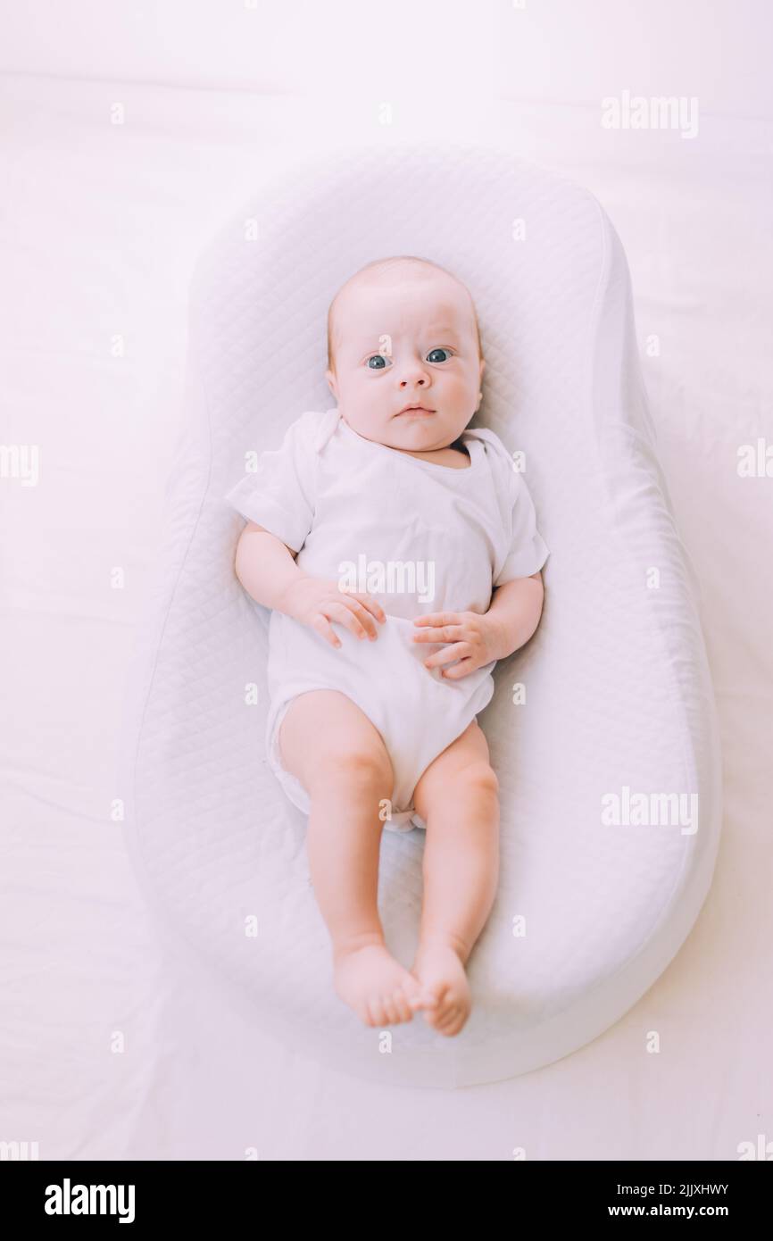 The baby is lying in a cocoon of copy space . The baby is 0-3 months ...