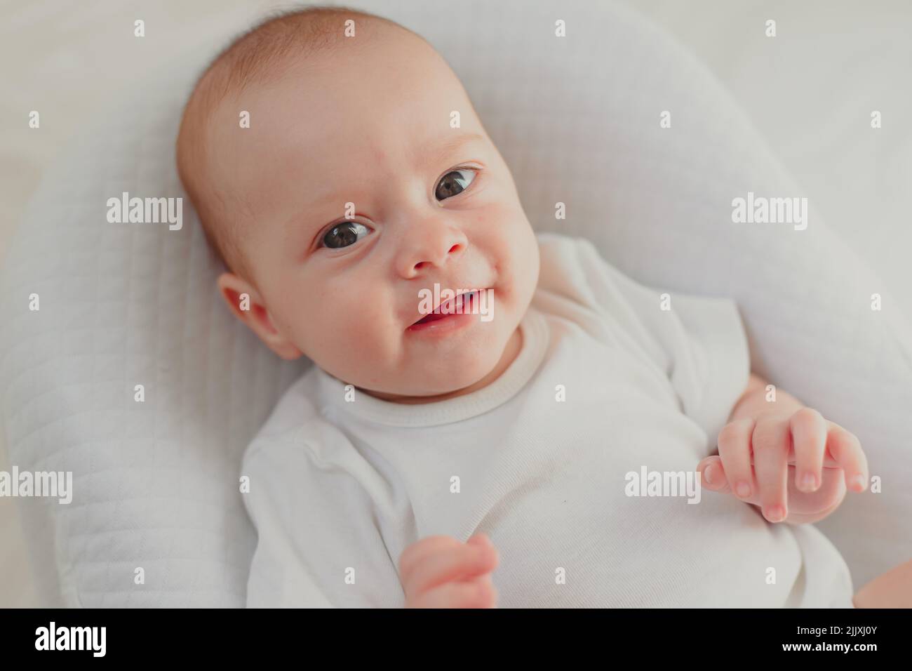 The baby is lying in a cocoon of copy space . The baby is 0-3 months ...