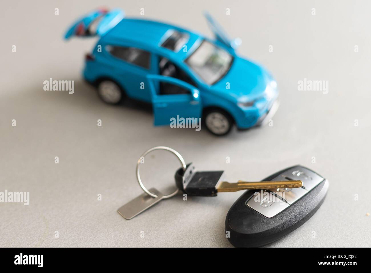 Toy car and keys car on white background Stock Photo - Alamy