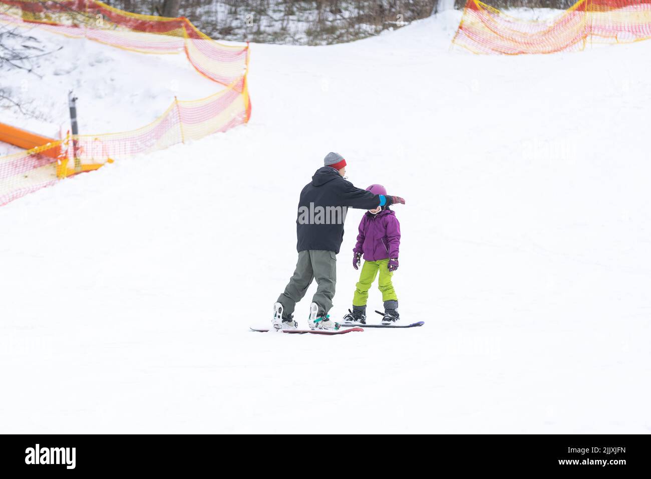 Ski Resort Father Teaching Little Daughter Snowboarding Stock Photo - Alamy