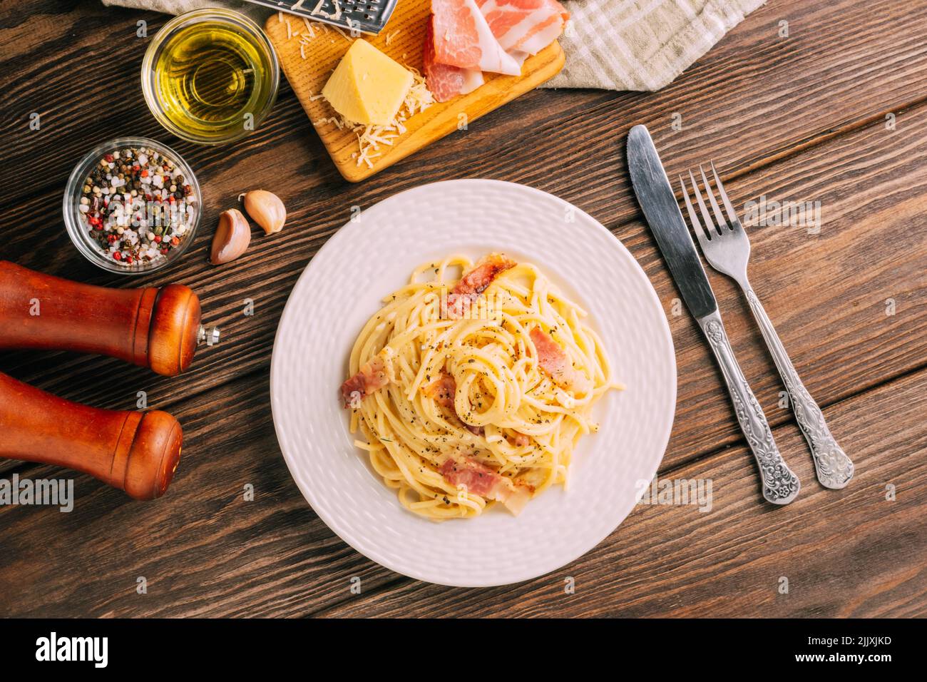 Classic italian pasta carbonara on white plate wooden tabletop, rustic ...