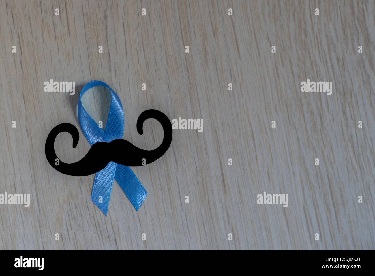 Prostate Cancer Awareness, light Blue Ribbon with mustache on wooden ...