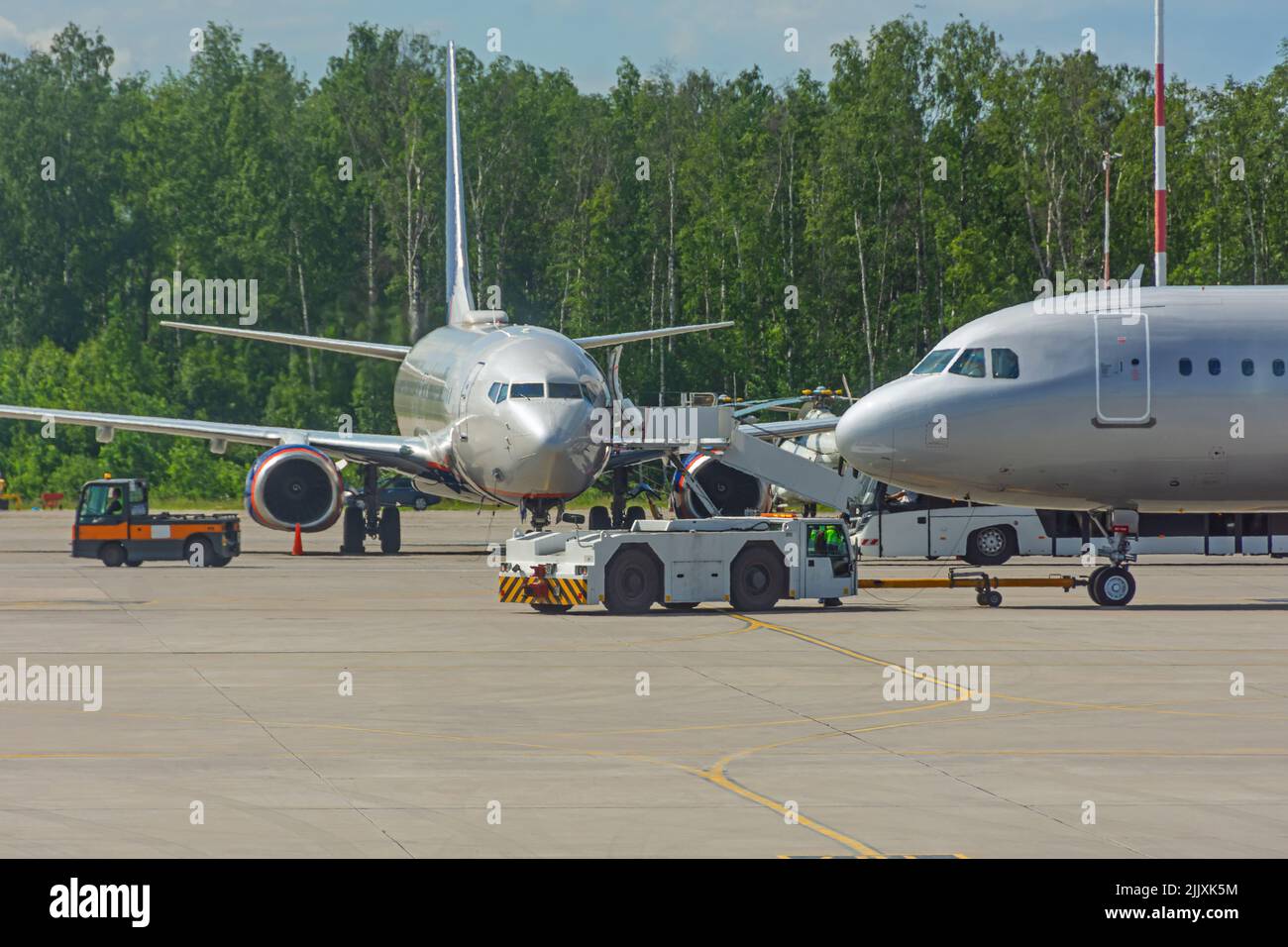 Airplane with a ladder ladder waiting for passengers, in the distance ...
