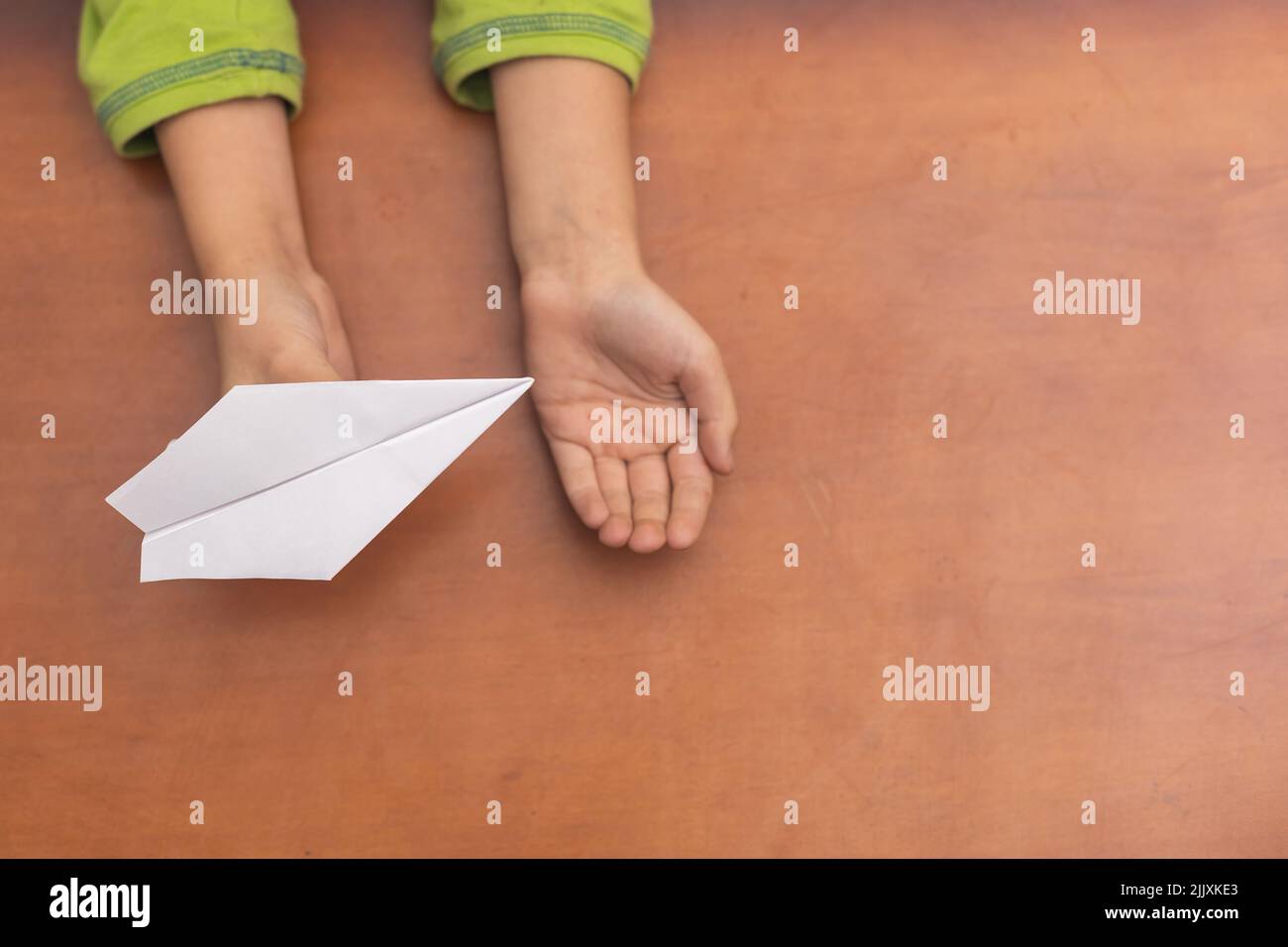 Child's Dream. Child's hand launching white paper airplane Stock Photo ...