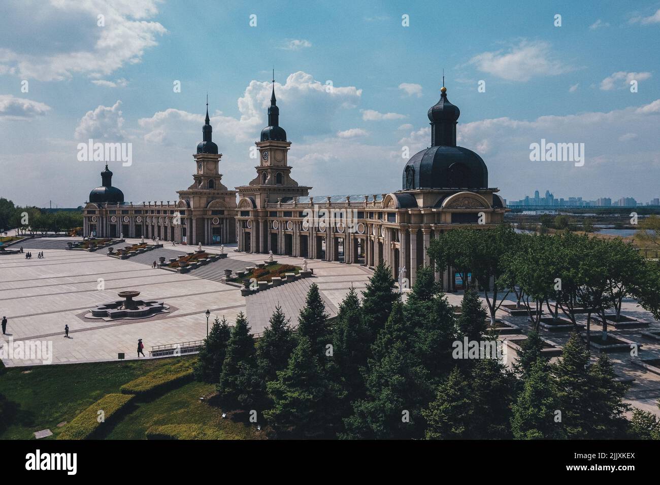 the Harbin Music Park Corridor with cloudy sky and trees in foreground ...