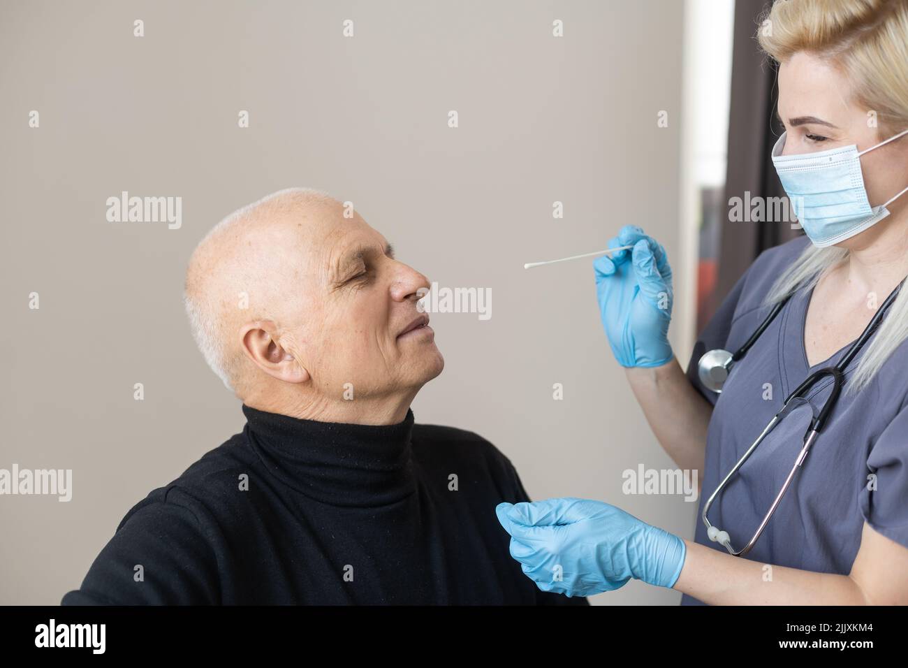 Close up of medical staff hands introducing the nasal swab to the ...