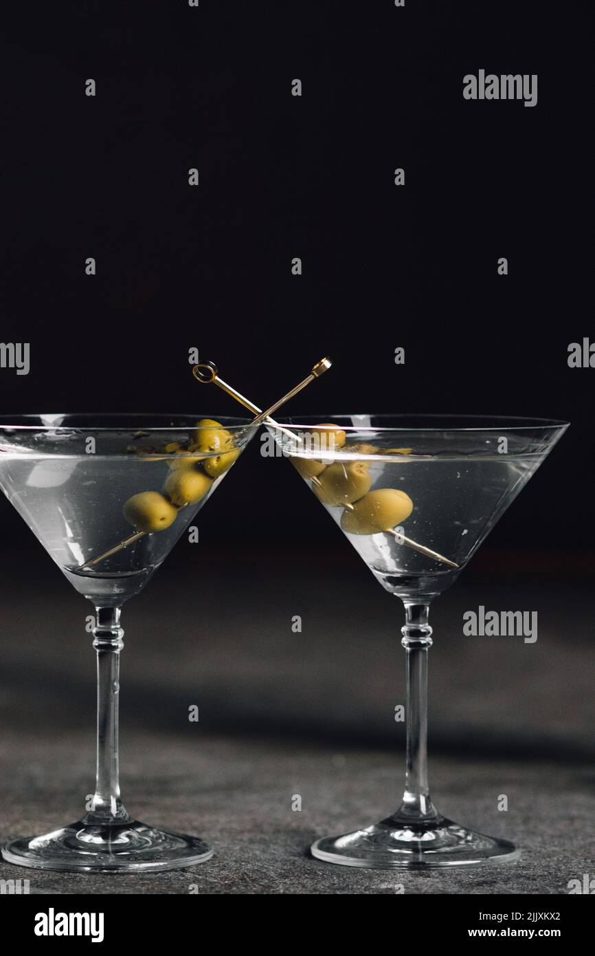 two martini glasses with olives on cocktail picks Stock Photo - Alamy