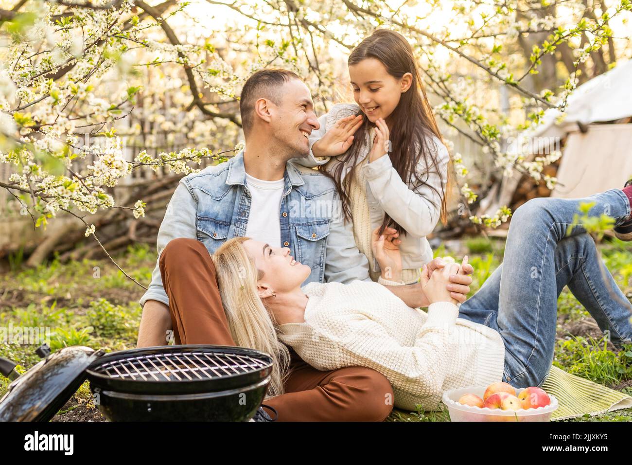 Happy family having barbecue with modern grill outdoors Stock Photo - Alamy