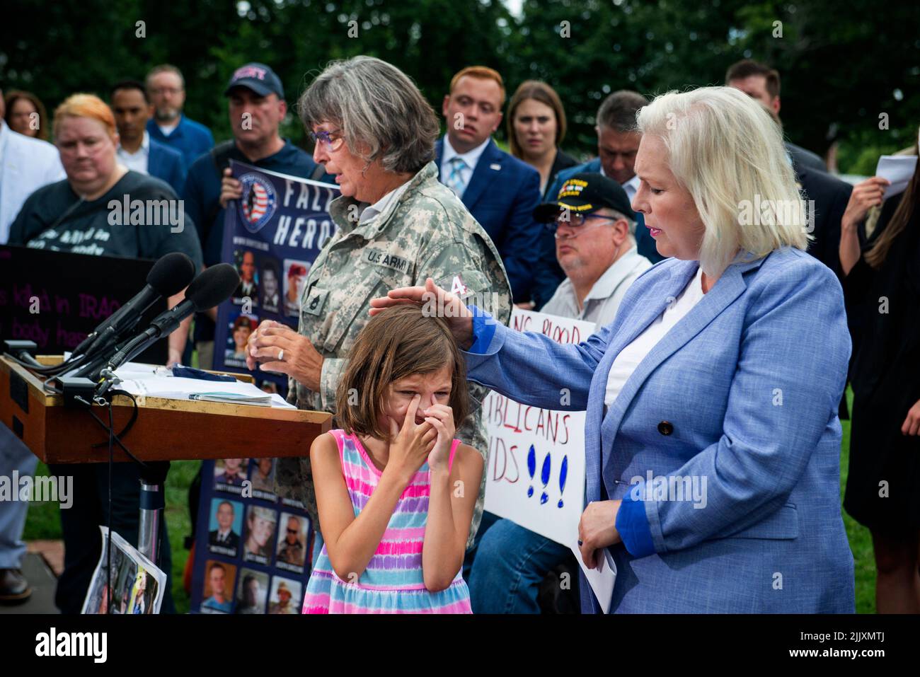Brielle Robinson, 9, second from right, is comforted by United States ...