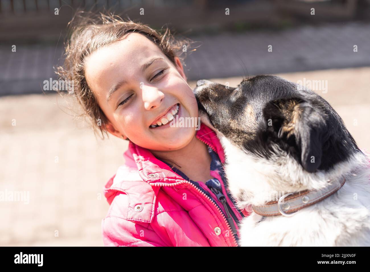 poor little girl with a dog in village Stock Photo - Alamy