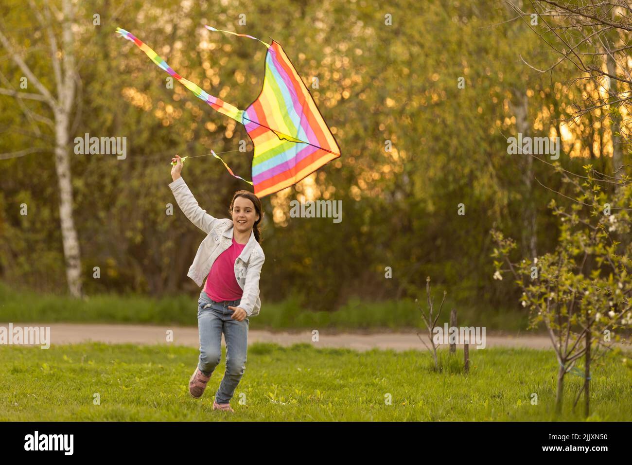 Little girl flying a kite running outdoor with a kite Stock Photo - Alamy