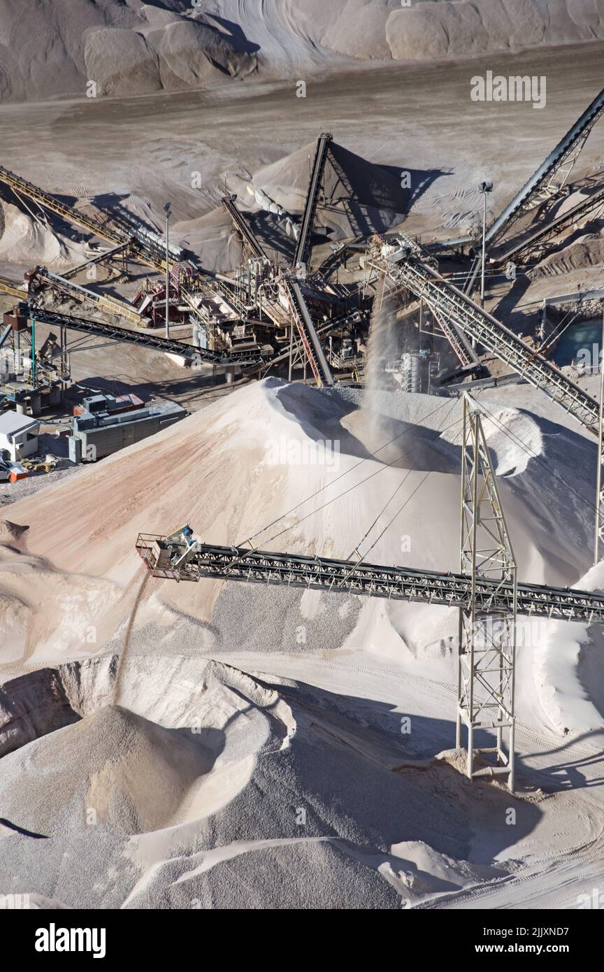 aggregate mine piles viewed from above with conveyor belts dumping ...