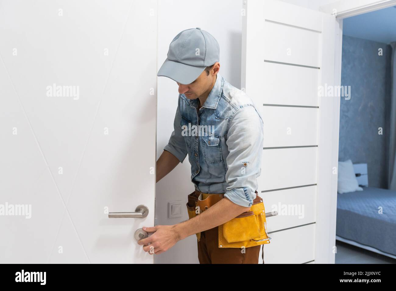 Handyman Installing And Fixing Automatic Door Closer. Maintenance And ...