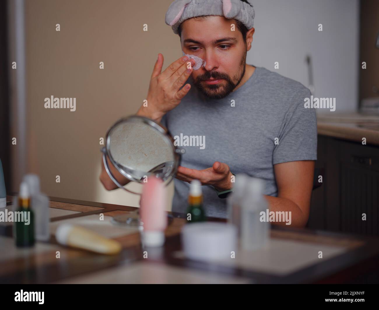 Men's beauty concept. caucAsian guy checking his skin. man looking into ...