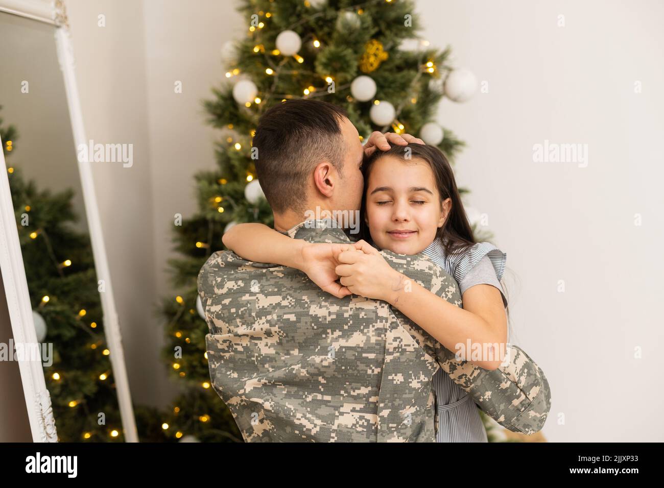 Armed Forces Soldier Hugging his daughter In Front Christmas Tree Stock ...