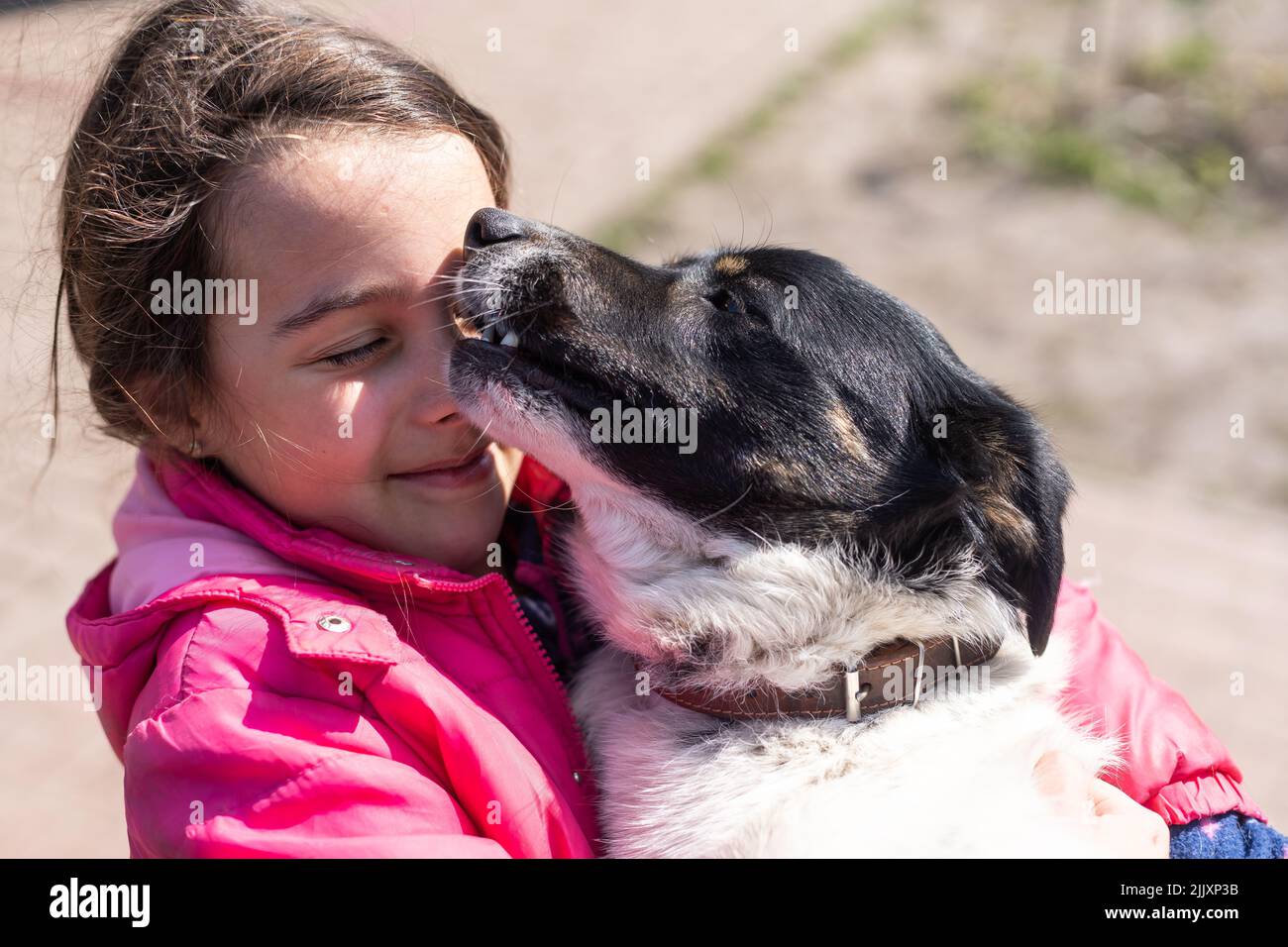 poor little girl with a dog in village Stock Photo - Alamy