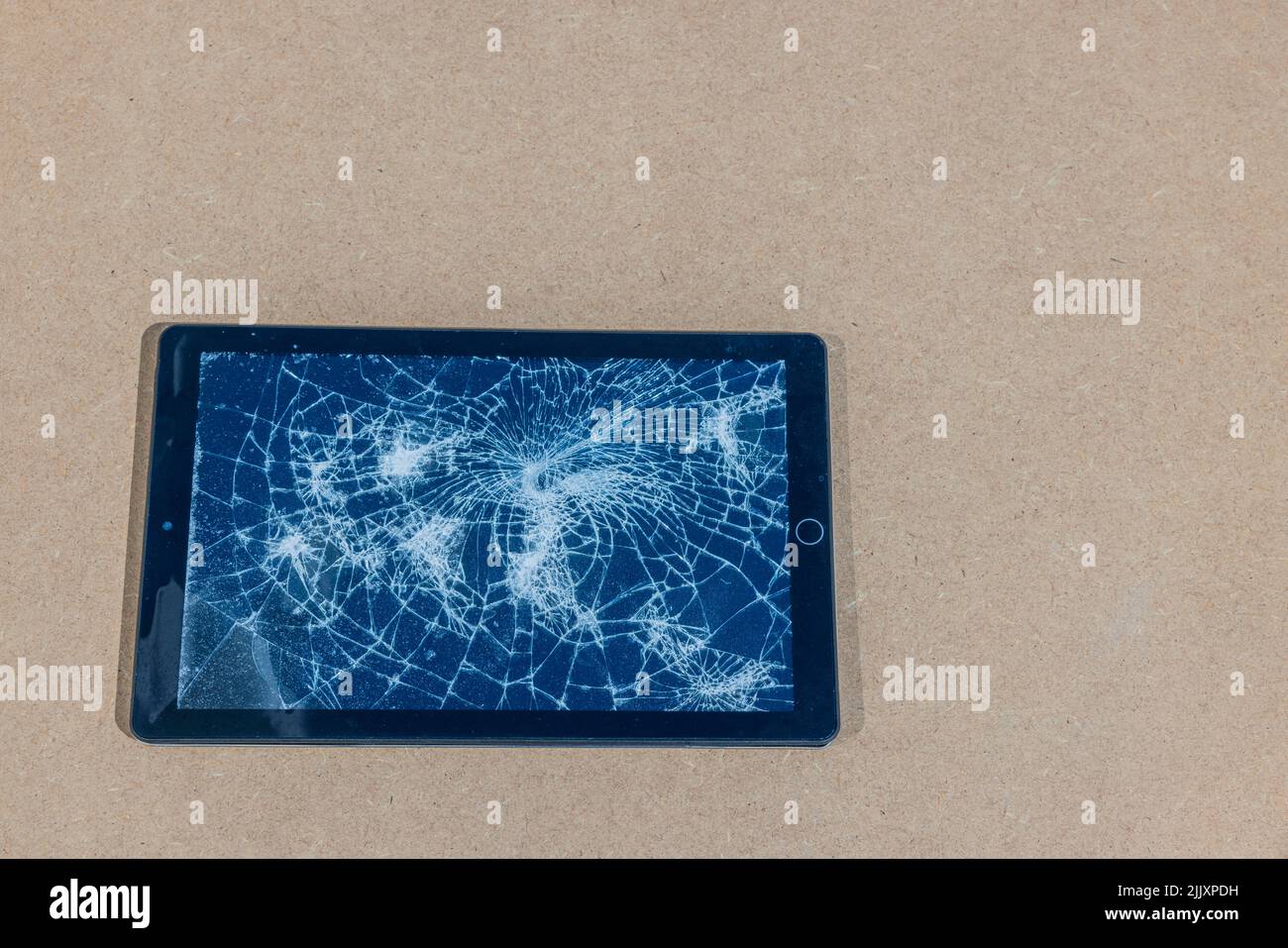 Close up view of electronic tablet with damaged screen isolated on gray ...