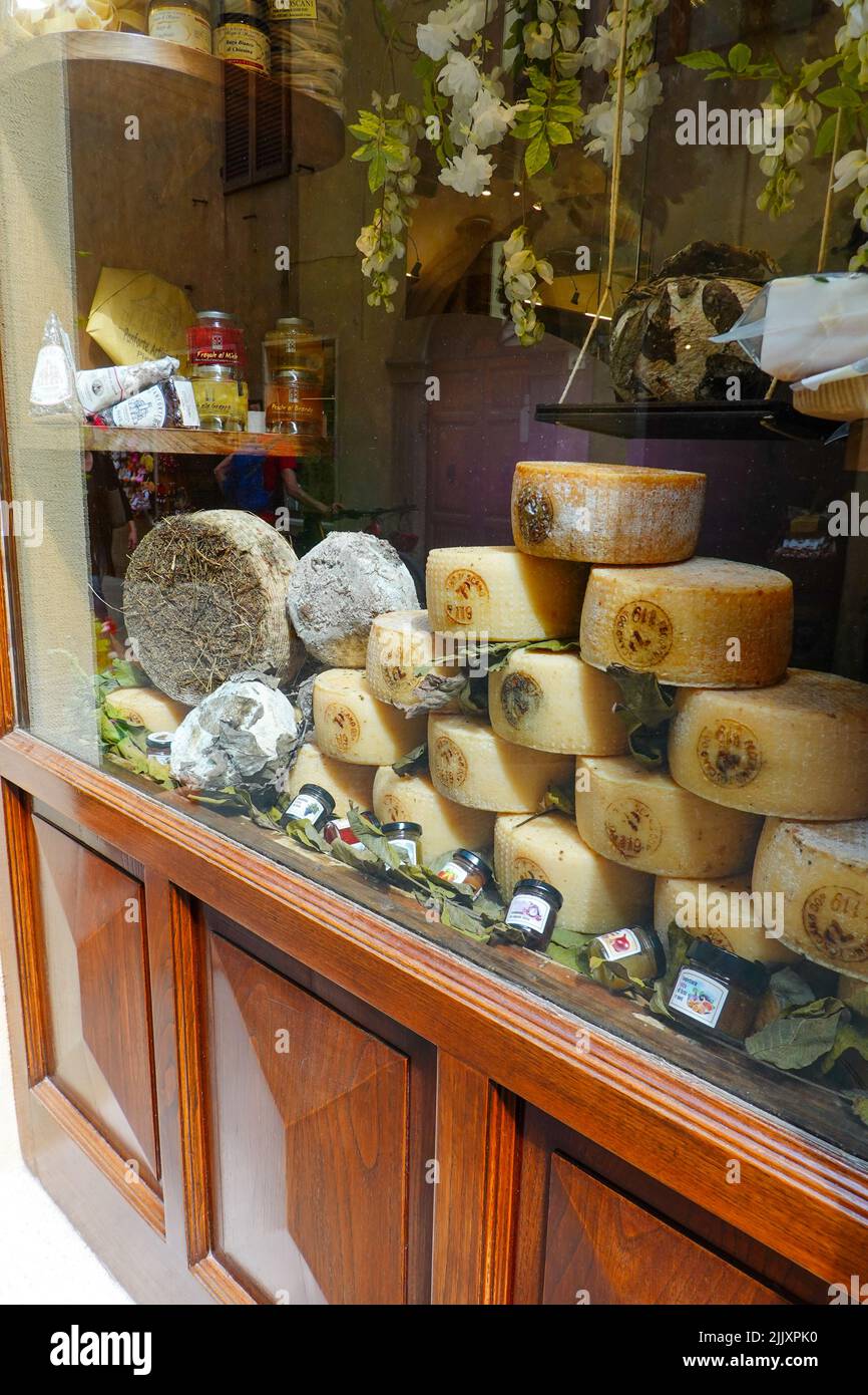 Wheels of Italian Val d’Orcia cheese displayed in cheese shop window ...