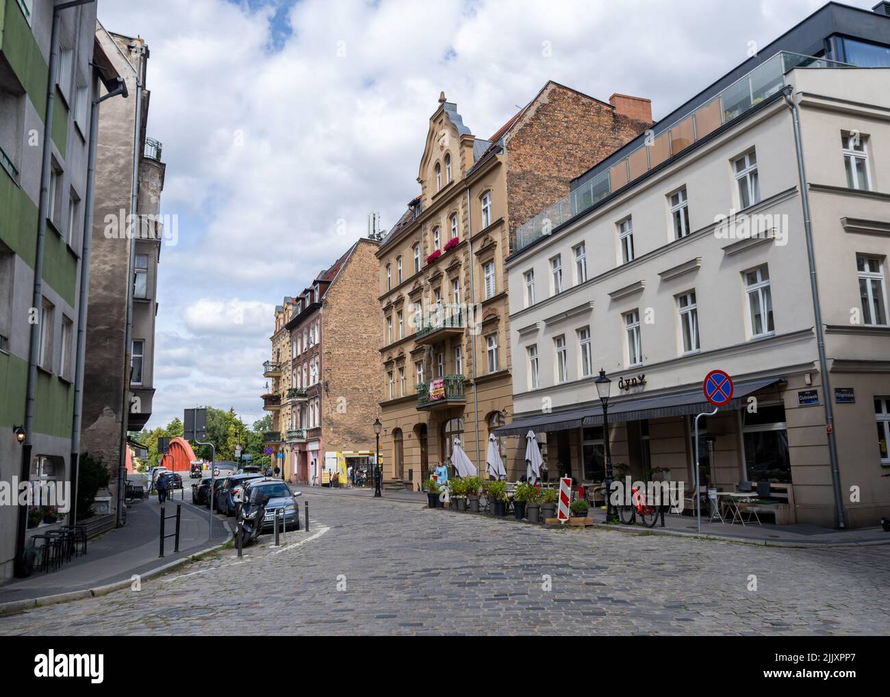 Ostrowek street with people, cars, cafes, and Dynx restaurant Stock ...