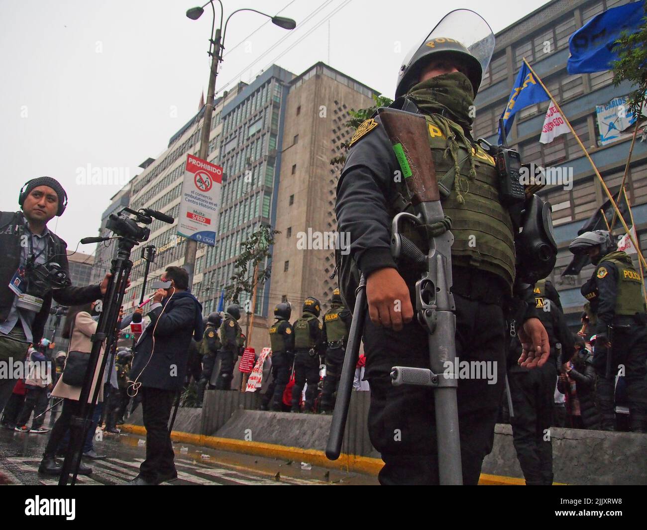 Police guarding the streets when on Peru's independence day, hundreds gather in the streets to ...