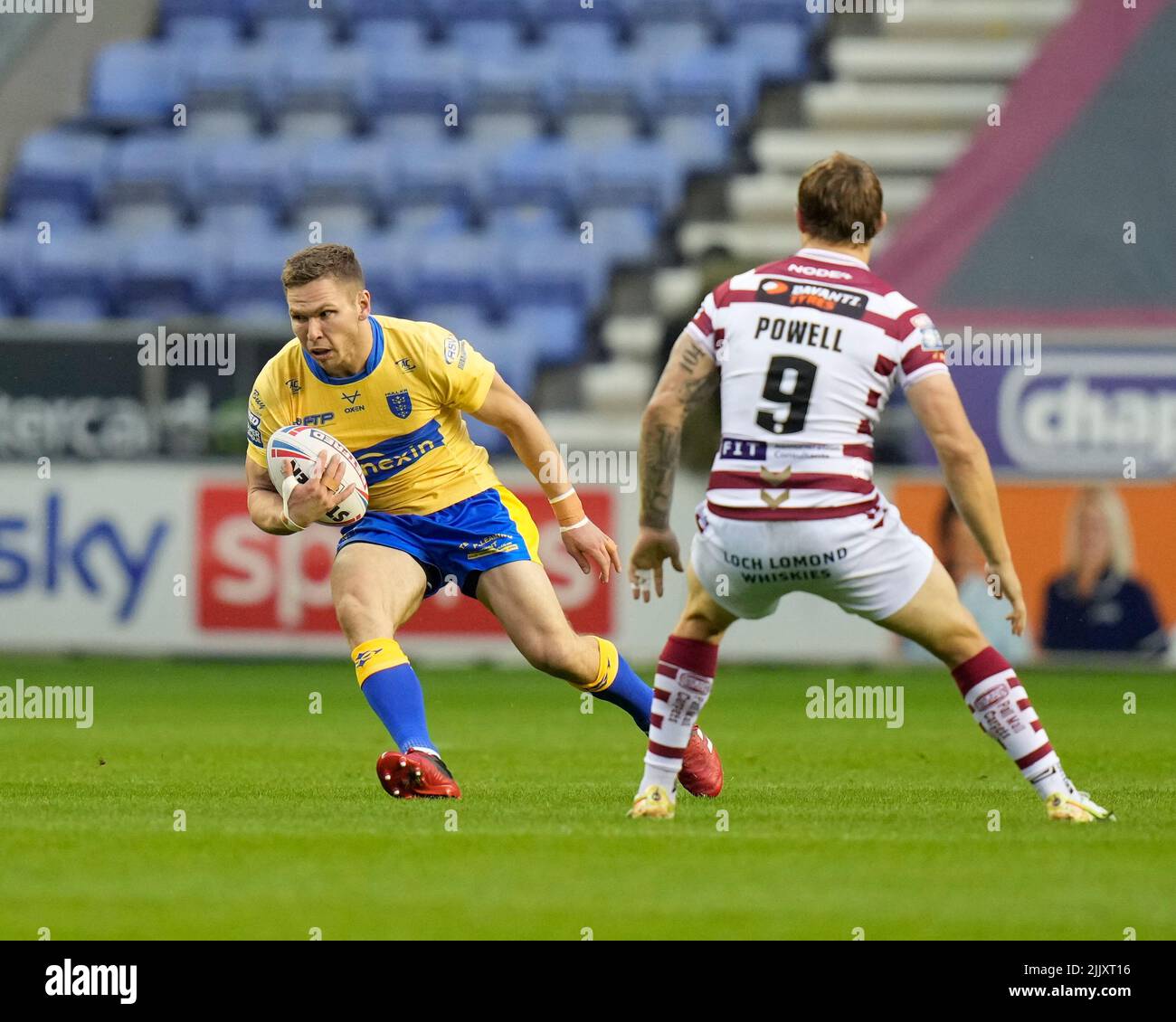 Matt Parcell #9 of Hull KR side steps Sam Powell #9 of Wigan Warriors ...