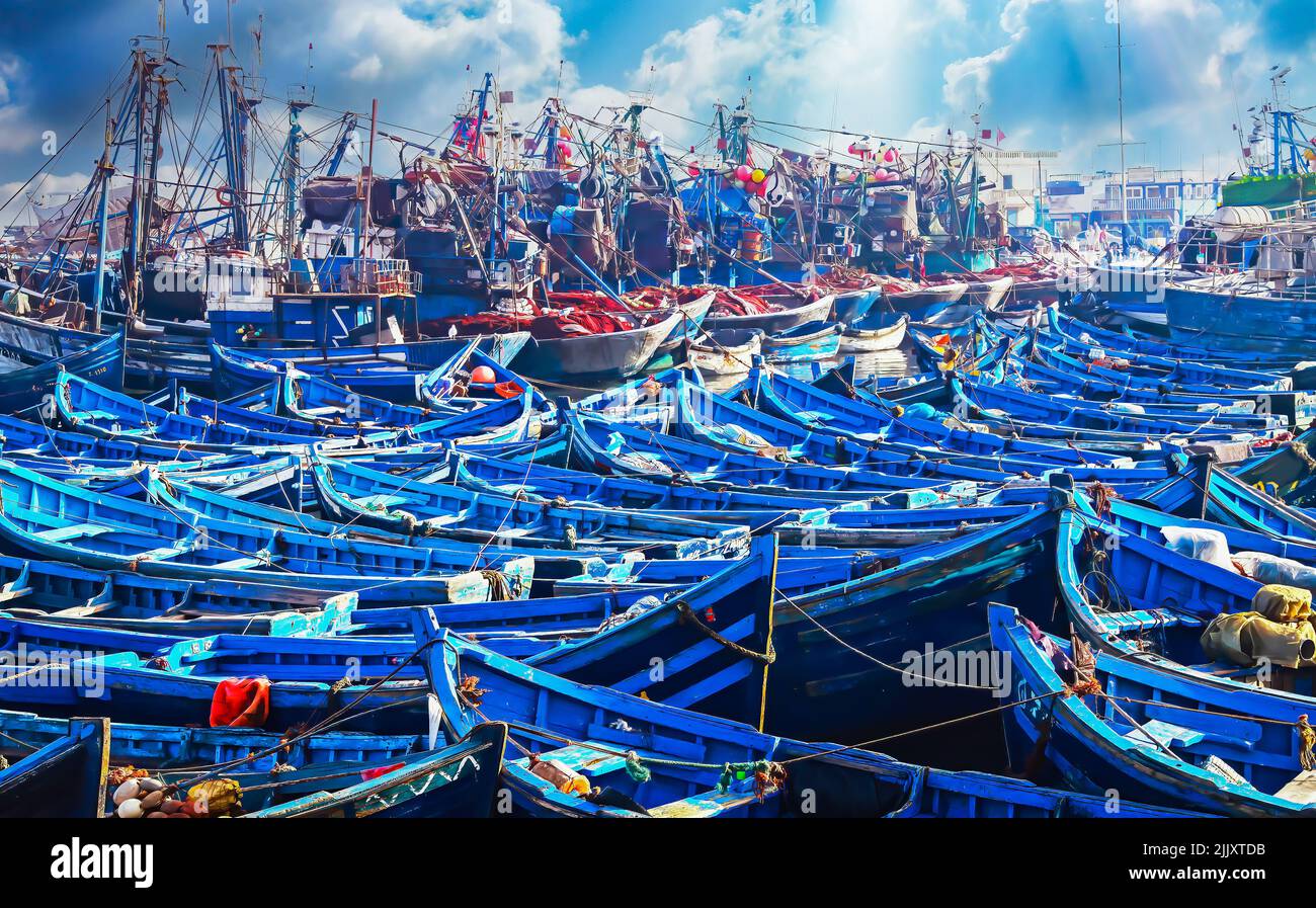 Countless old blue wooden traditional fishing boats crammed together in ...