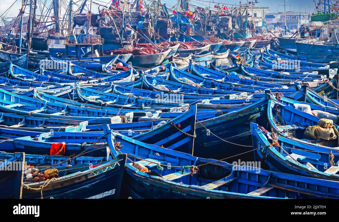 Countless old blue wooden traditional fishing boats crammed together in ...
