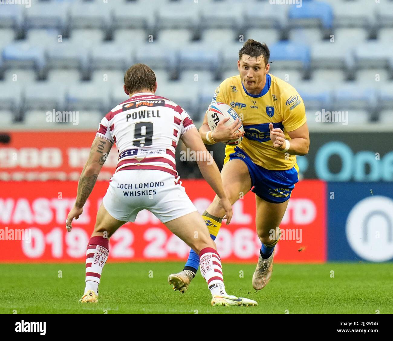 Sam Wood #24 of Hull KR runs at Sam Powell #9 of Wigan Warriors Stock ...