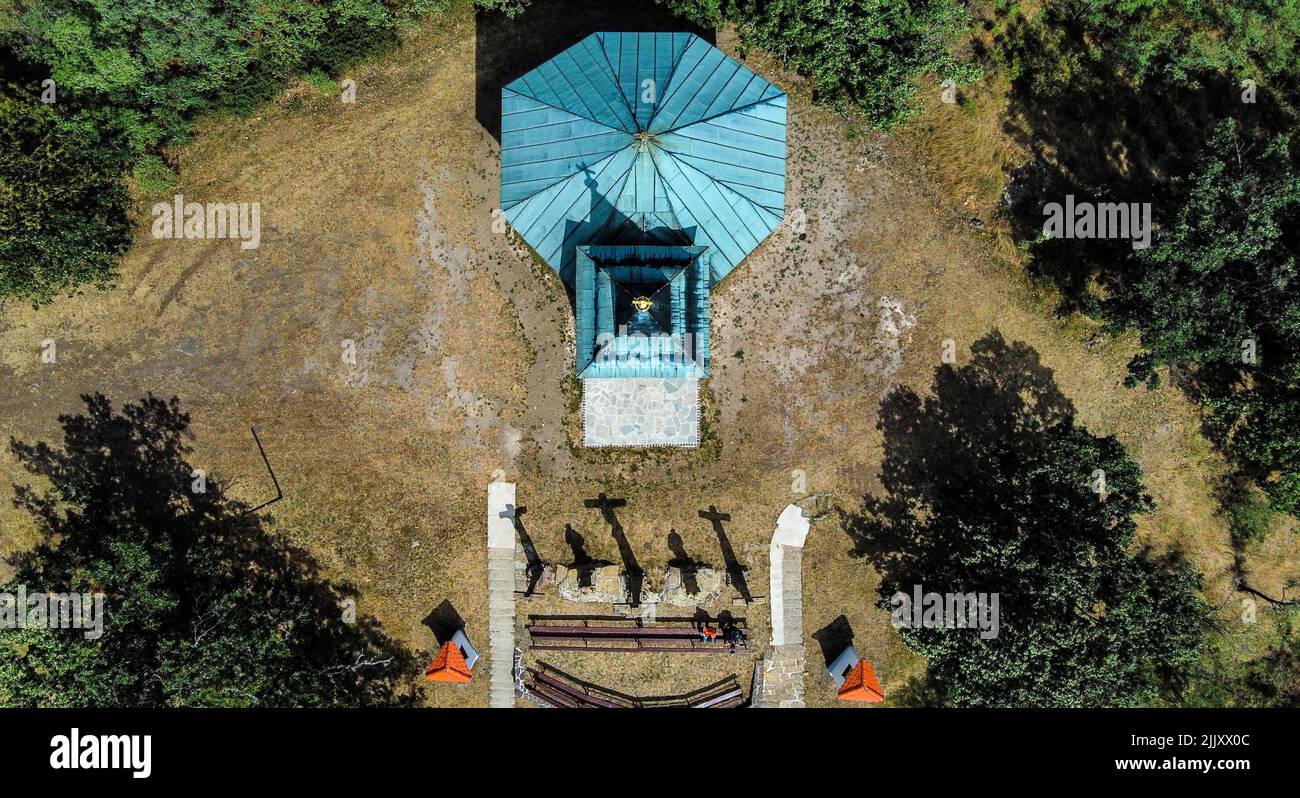 An aerial top view of an old graveyard with crosses and a small church ...