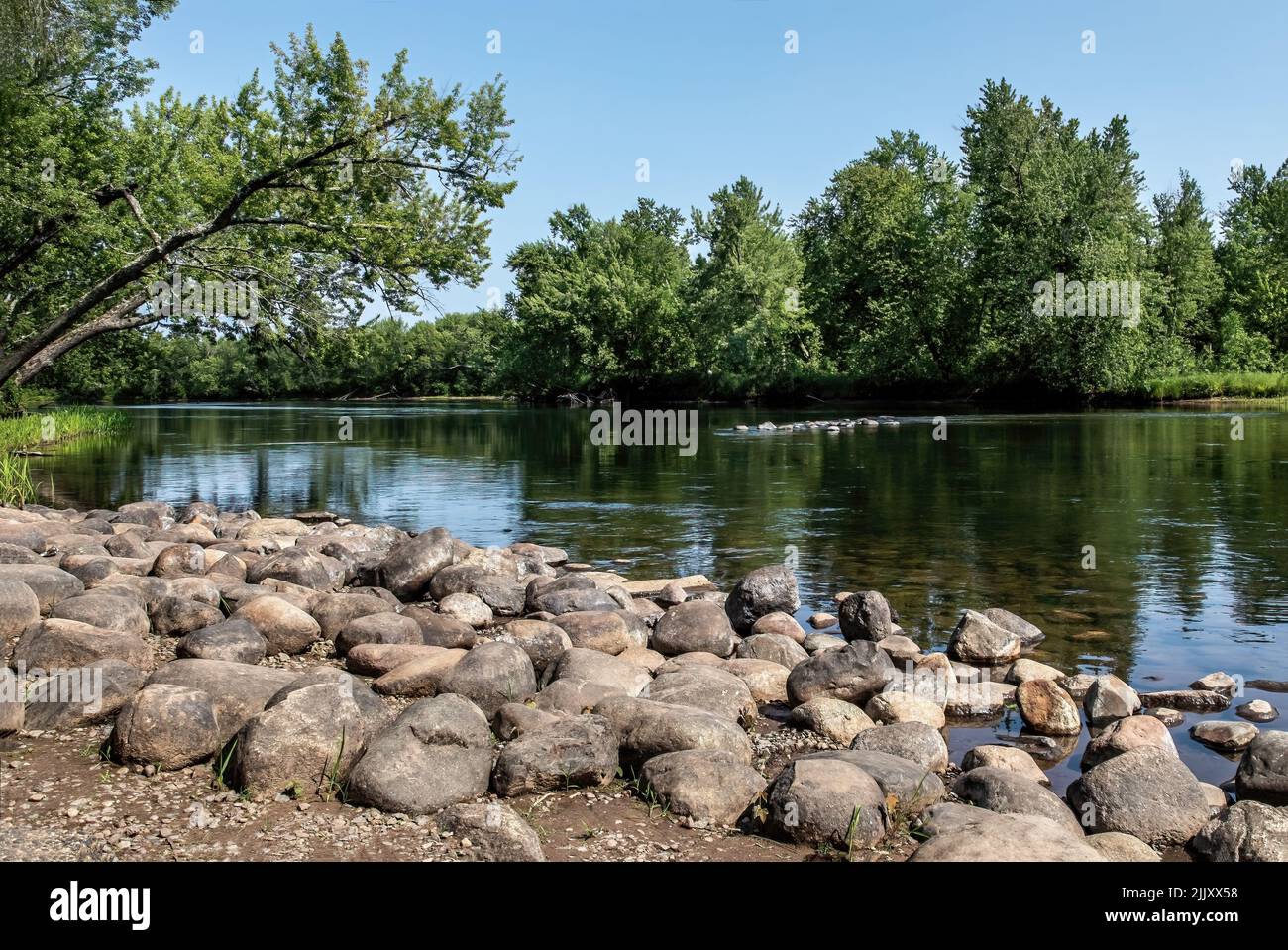 Rocks on the shoreline and in the water of the St. Croix River at St ...
