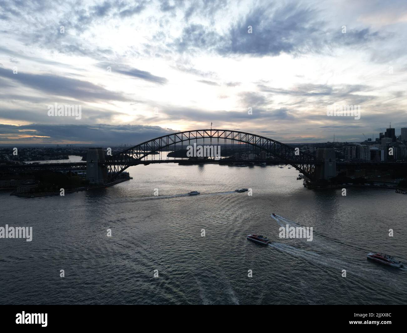 An aerial view of the Sydney harbor bridge on cloudy sky background at ...