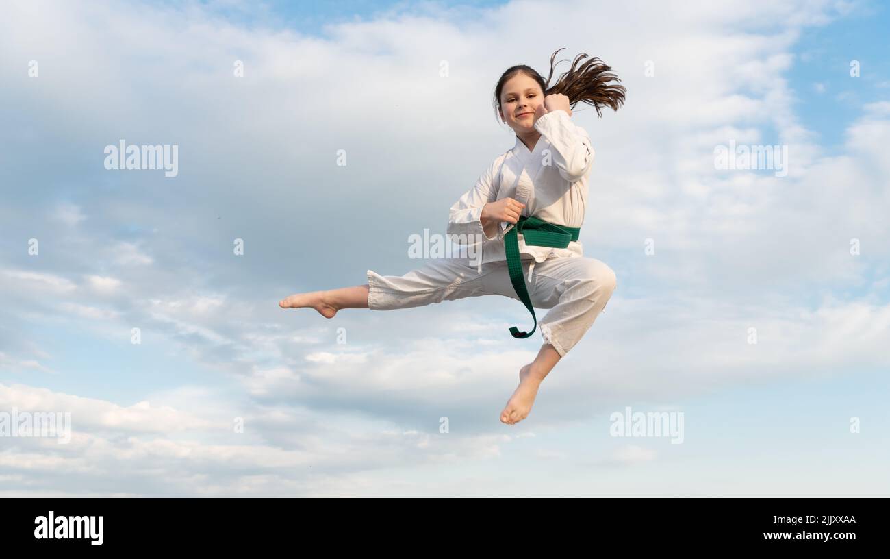 judo concept. teen girl practicing judo. girl judo fighter jumping on ...