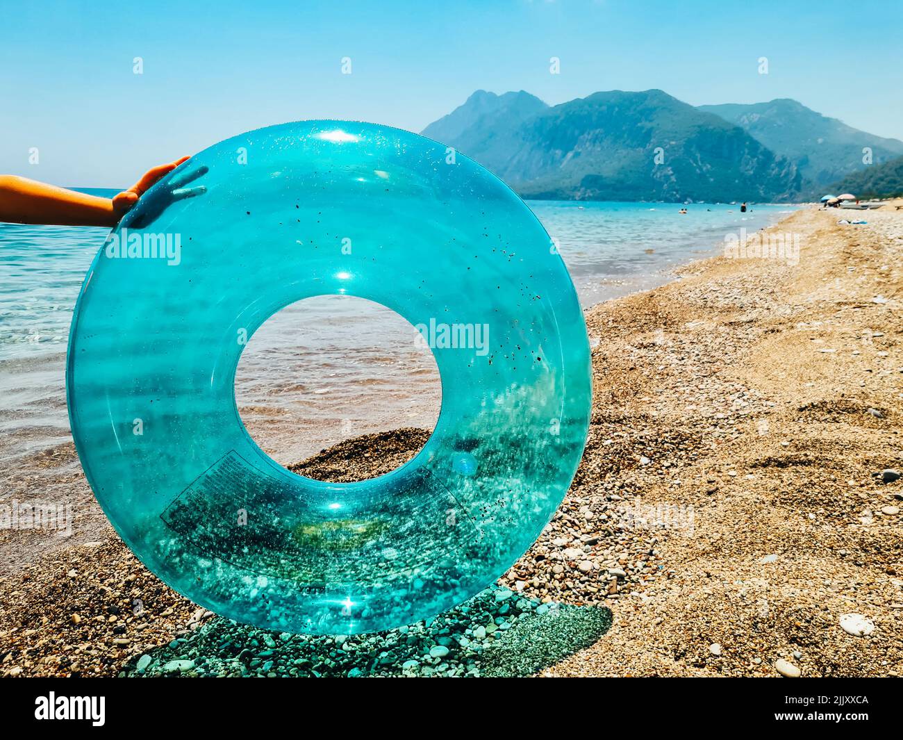 Blue inflatable swim ring float and sunglasses on the beach Stock Photo ...
