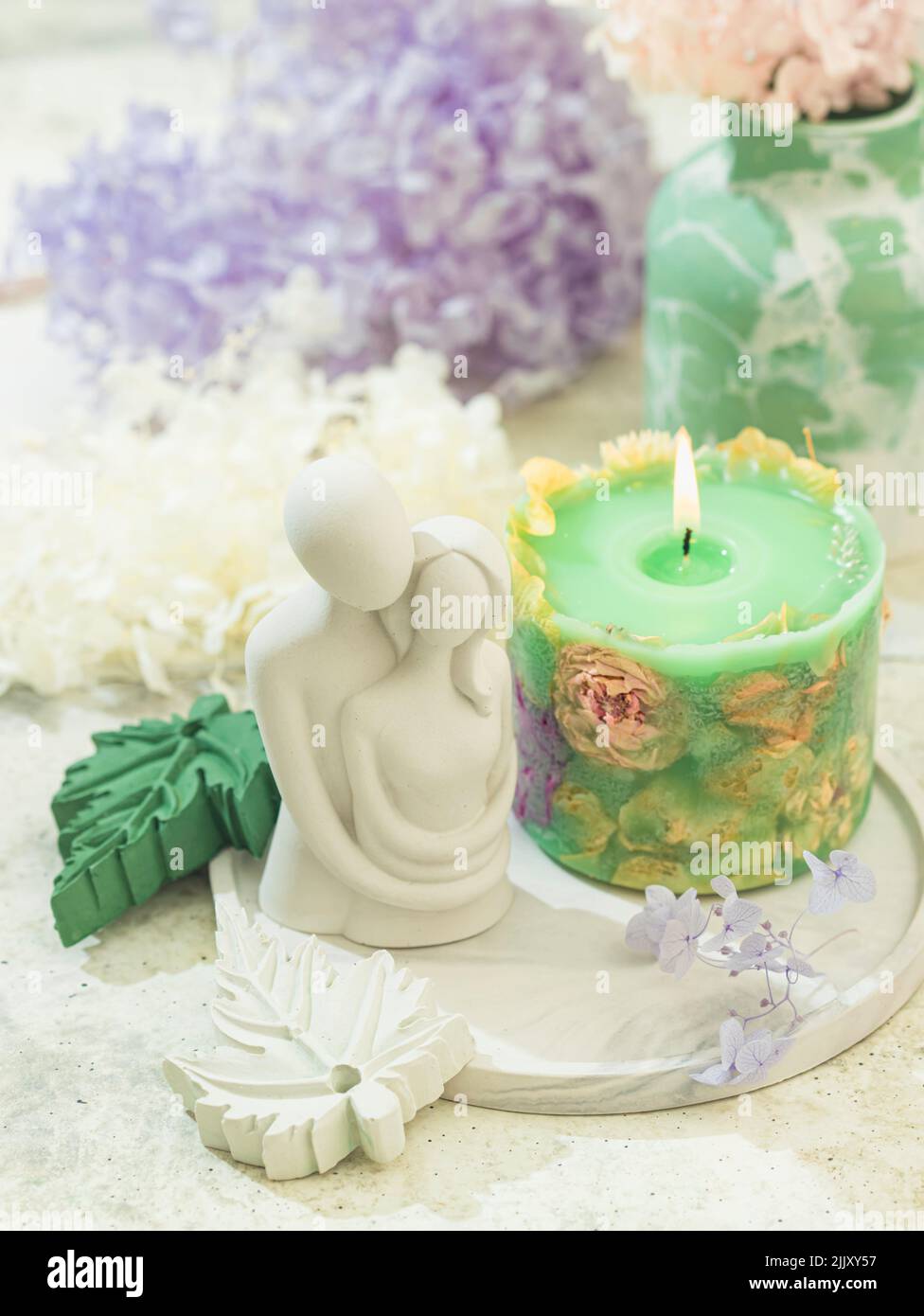 Handmade candles of a unique design, with different flowers, dry leaves ...