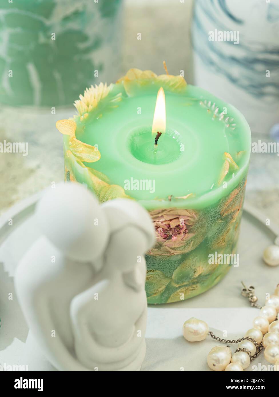 Handmade candles of a unique design, with different flowers, dry leaves ...