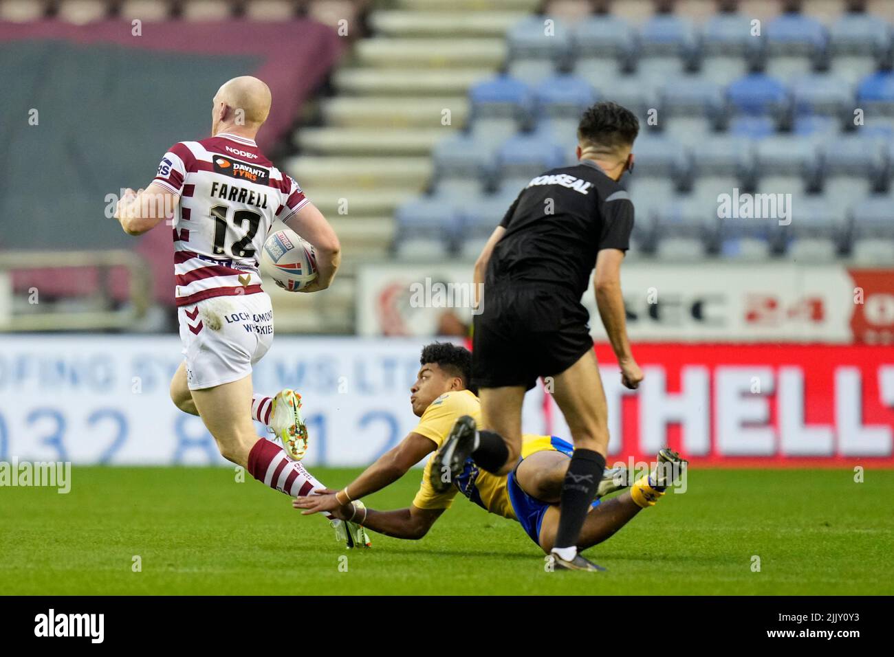 Phoenix Laulu-TogagaÕe #29 of Hull KR tap tackles Liam Farrell #12 of ...