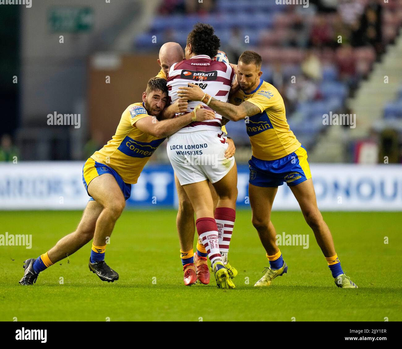Ben Crooks #2 and Sam Royle #36 of Hull KR tackle Patrick Mago #10 of ...