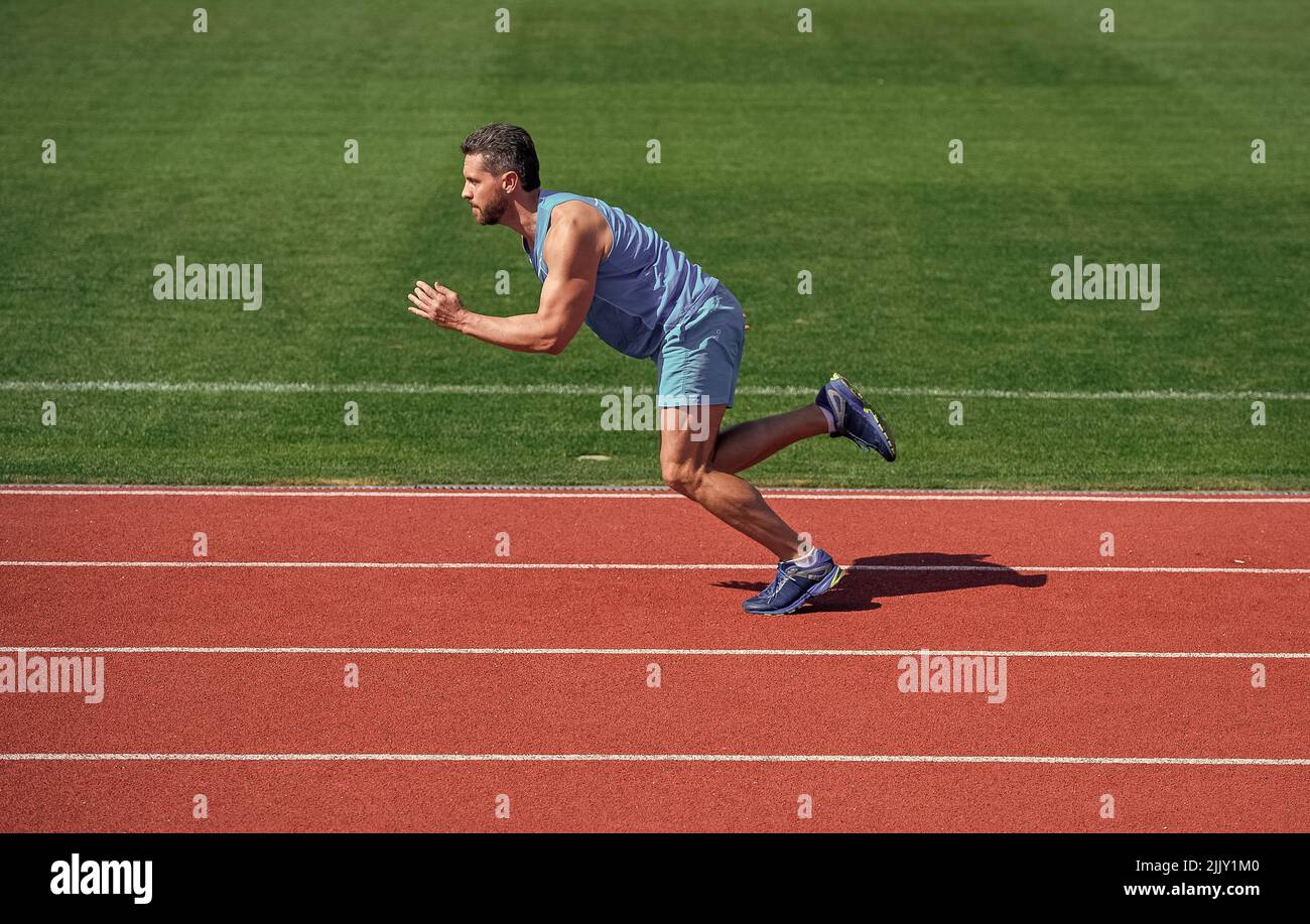 athletic muscular man running in sportswear on stadium track, finish ...