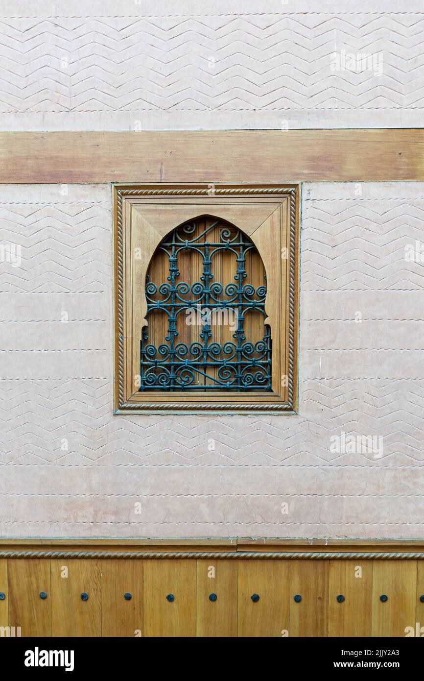 Tiny closed security window with wood and iron fence in old Arabian ...