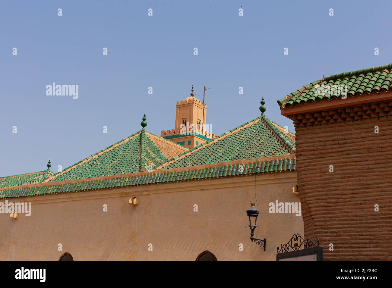 Arabian mosque tower peak in a skyline scene on a sunny blue sky in ...