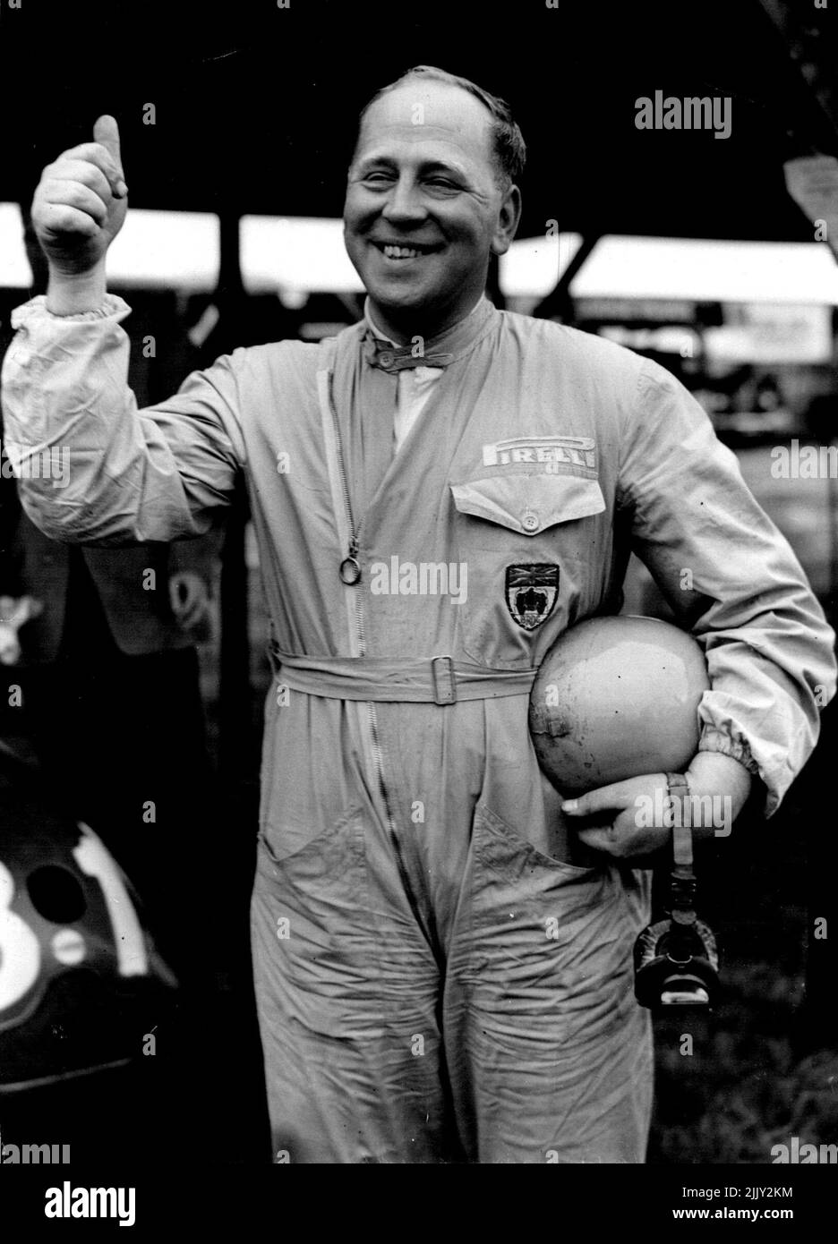 and confident, racing-driver Reg Parnell gives the 'thumbs-up' sign ...