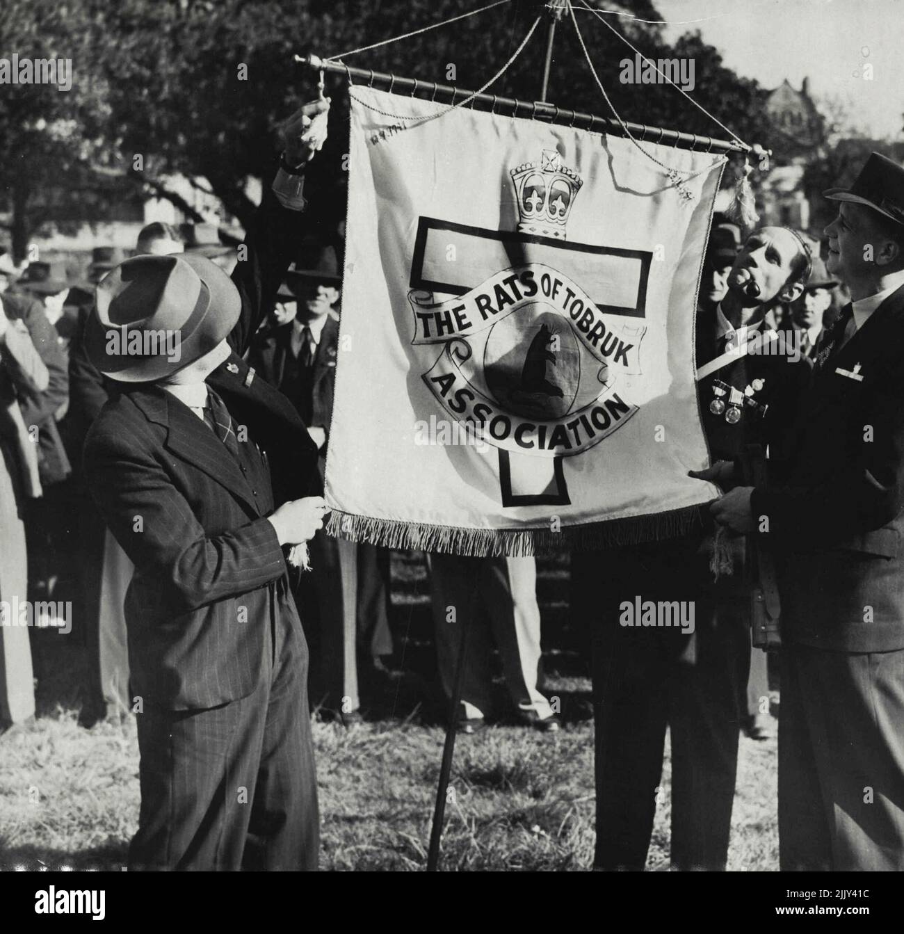 with their banner before the victory March in Sydney. June 15, 1946 ...
