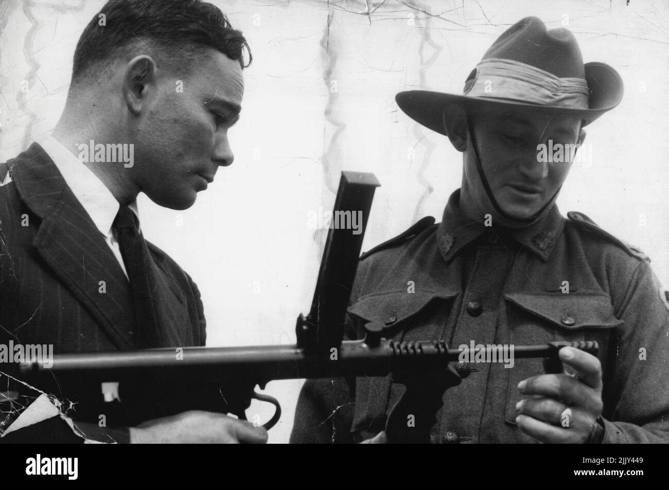 Evelyn Owen displays his "ludicrously simple" gun to a Digger. The ...