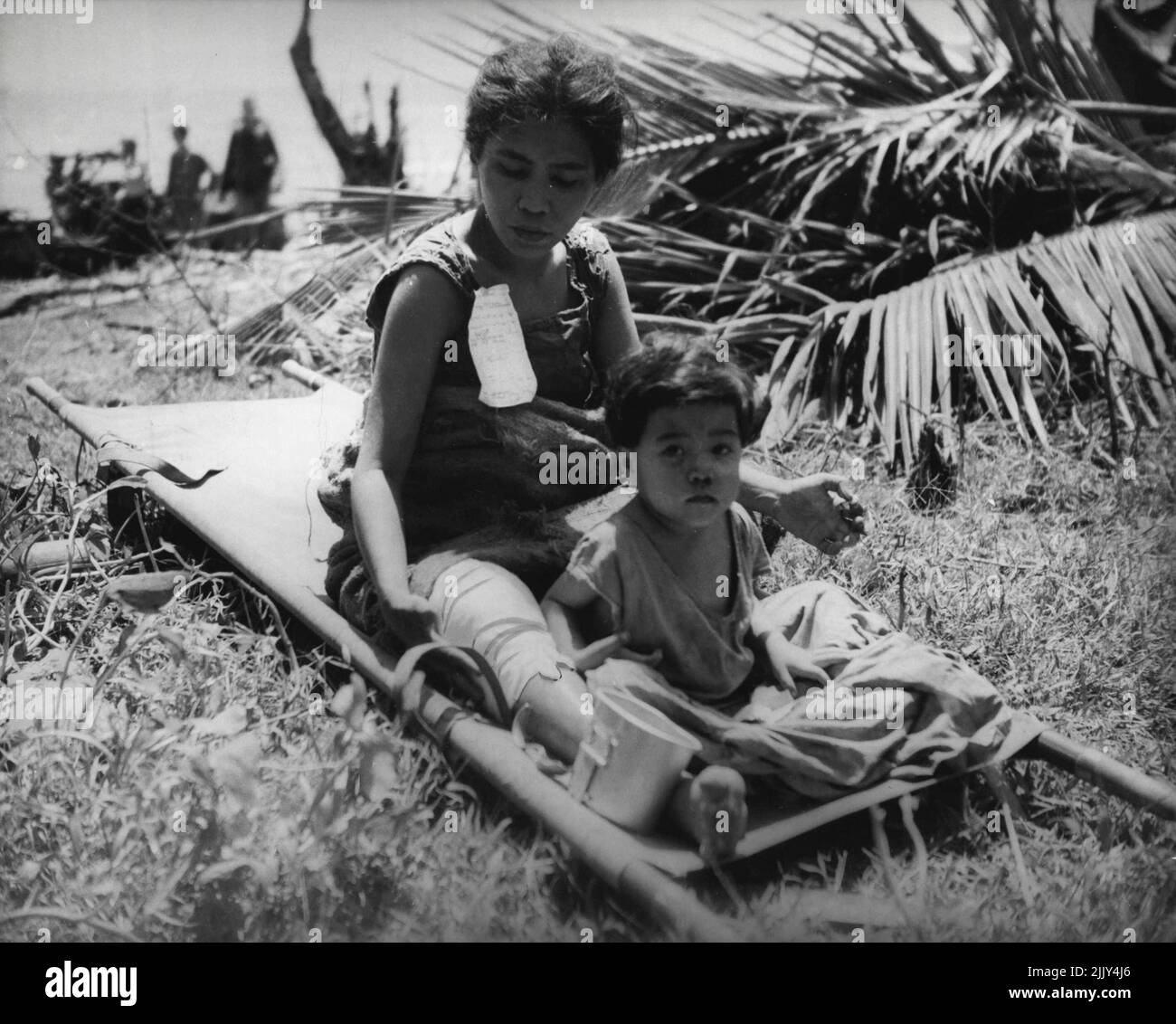 Casuality -- A Filipino mother and her child wait evacuation to a ...