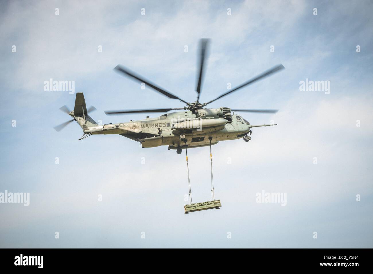 A CH-53E Super Stallion is used to lift a HIMARS launcher pod container ...