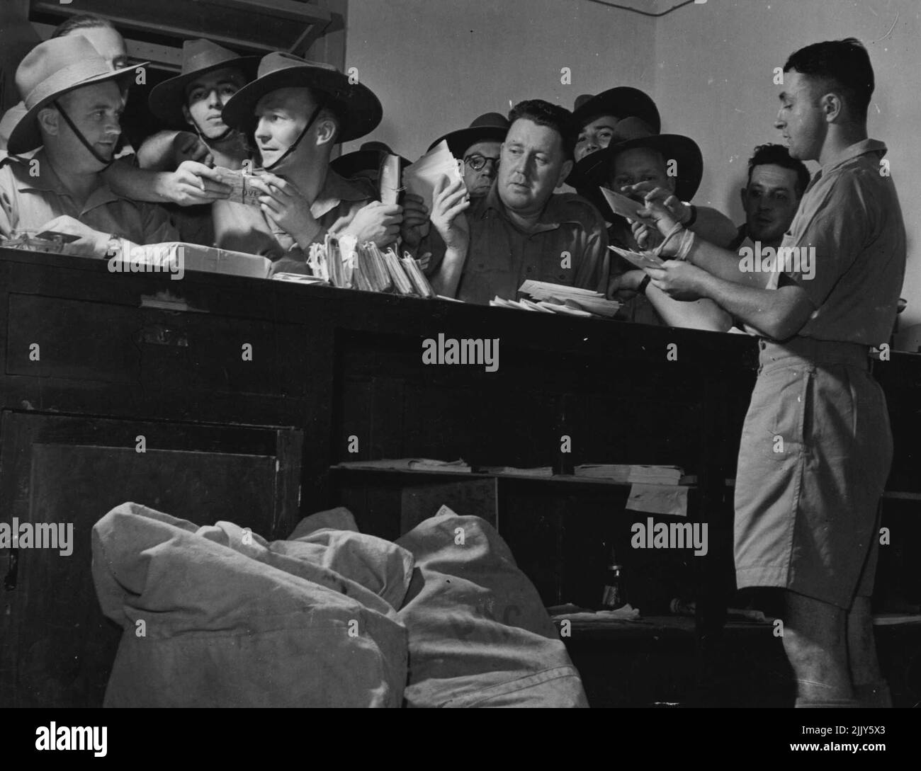 The Happiest Break In Their Routine -- Diggers collecting their mail. July 15, 1940 Stock Photo ...