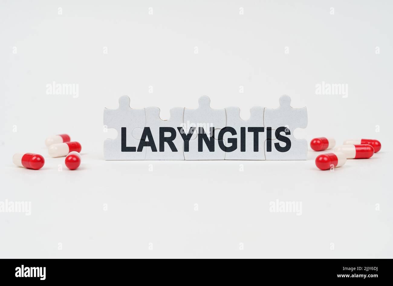 Medical concept. On a white surface are tablets and puzzles with the ...