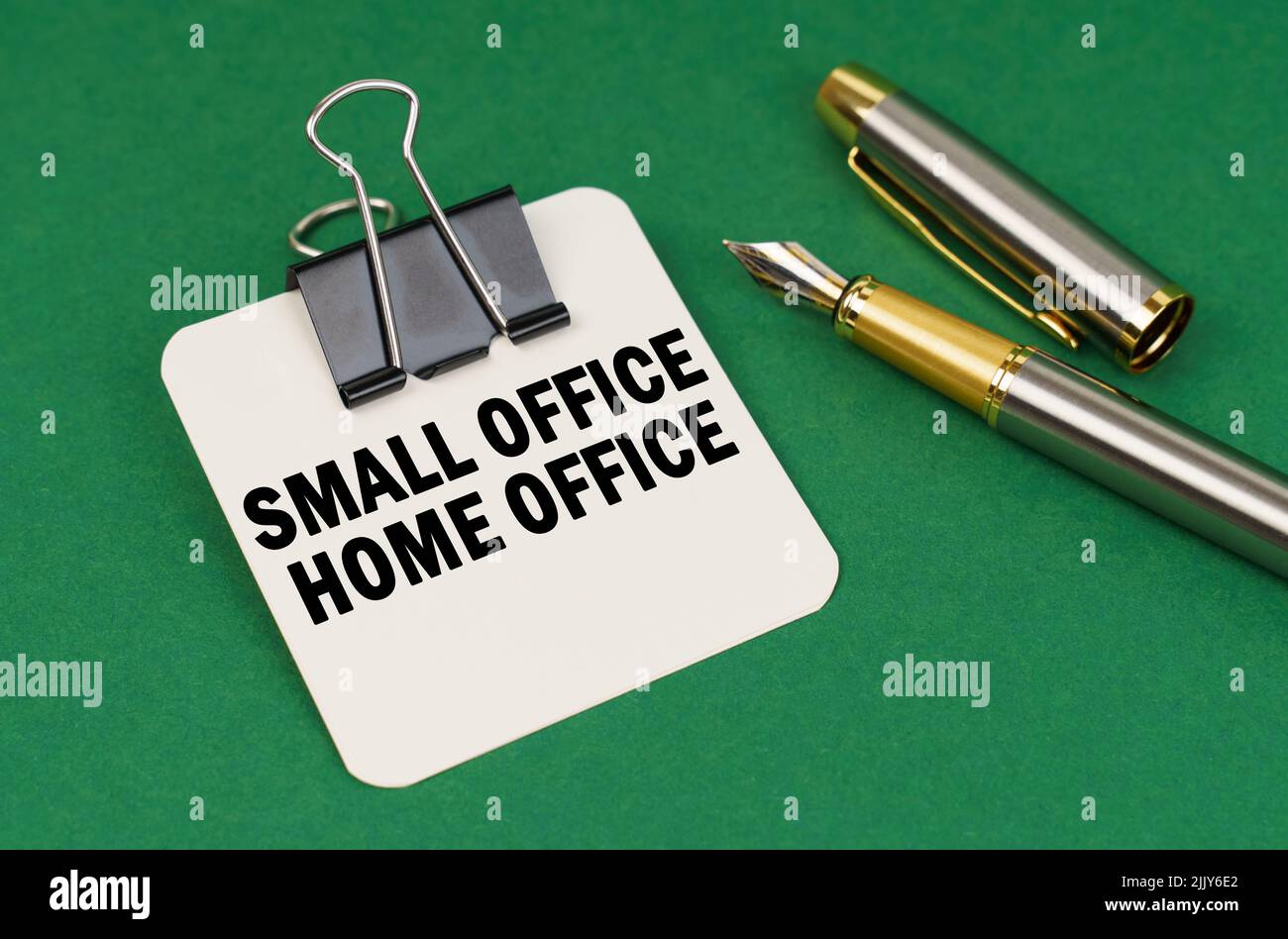 Business and industry concept. On a green surface, a pen and a sheet of ...